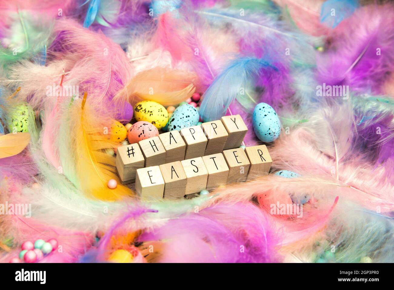 Happy Easter written with wooden cubes and hashtag surrounded with ...