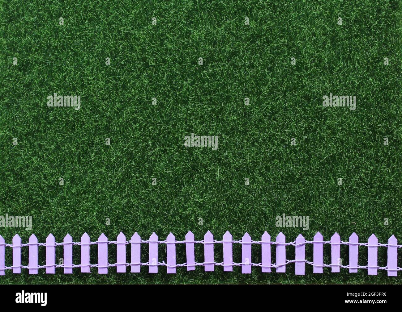 Picket Fence on Artificial Grass Background Stock Photo - Alamy