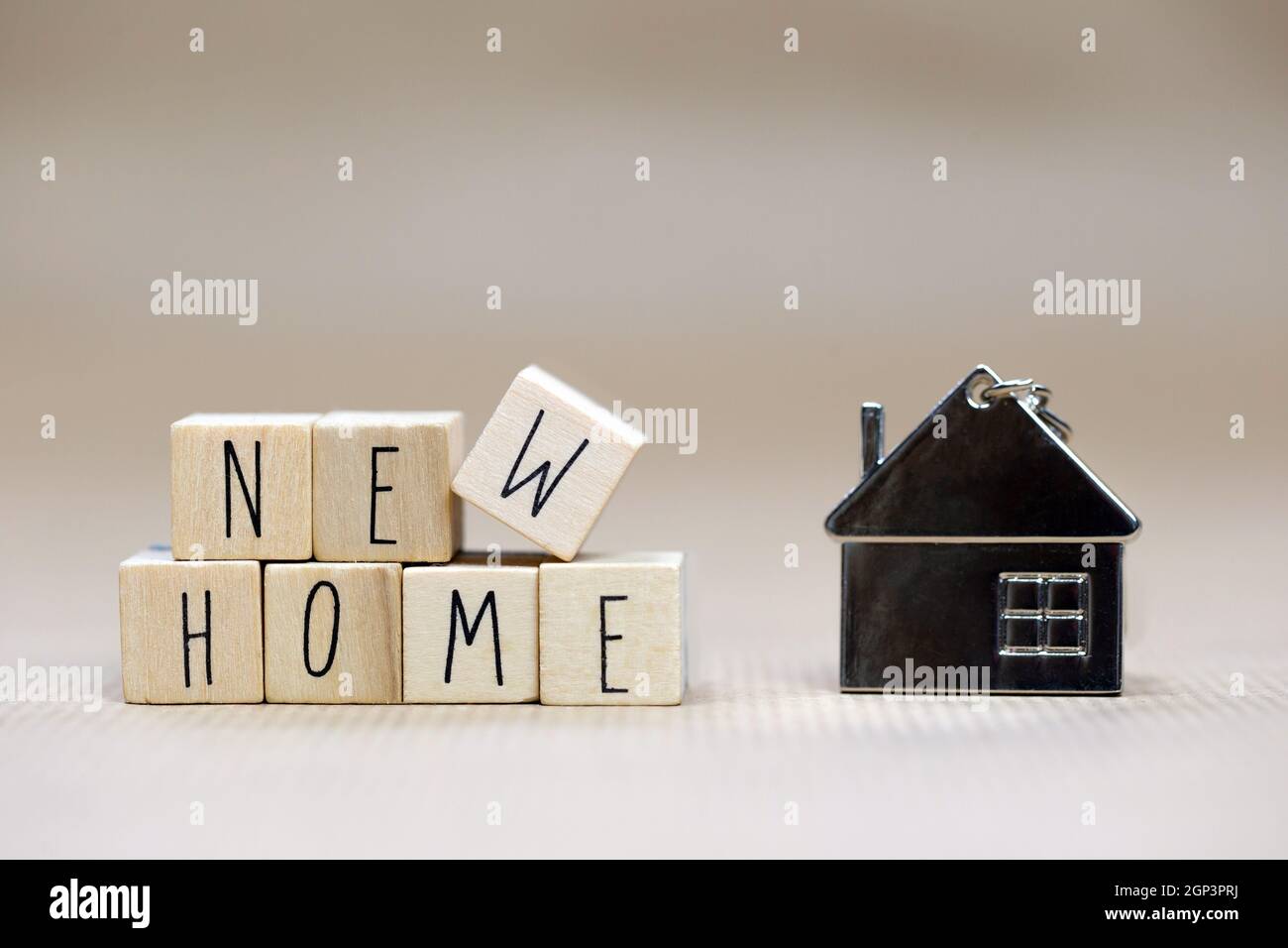 New Home text written with wooden cubes background with symbol of cozy ...