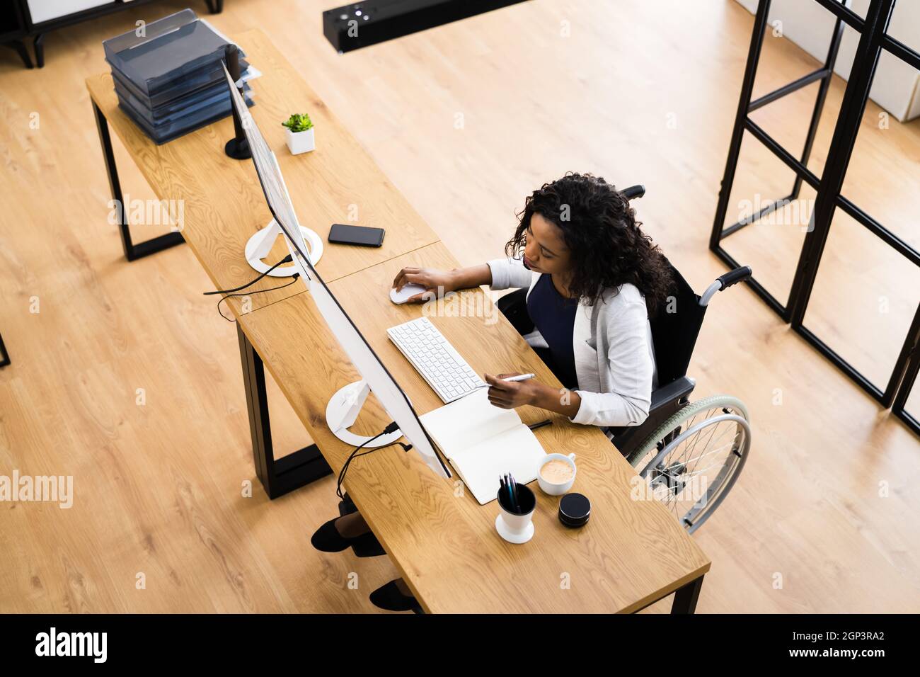 Disabled African Worker In Wheelchair Working On Computer Stock Photo ...