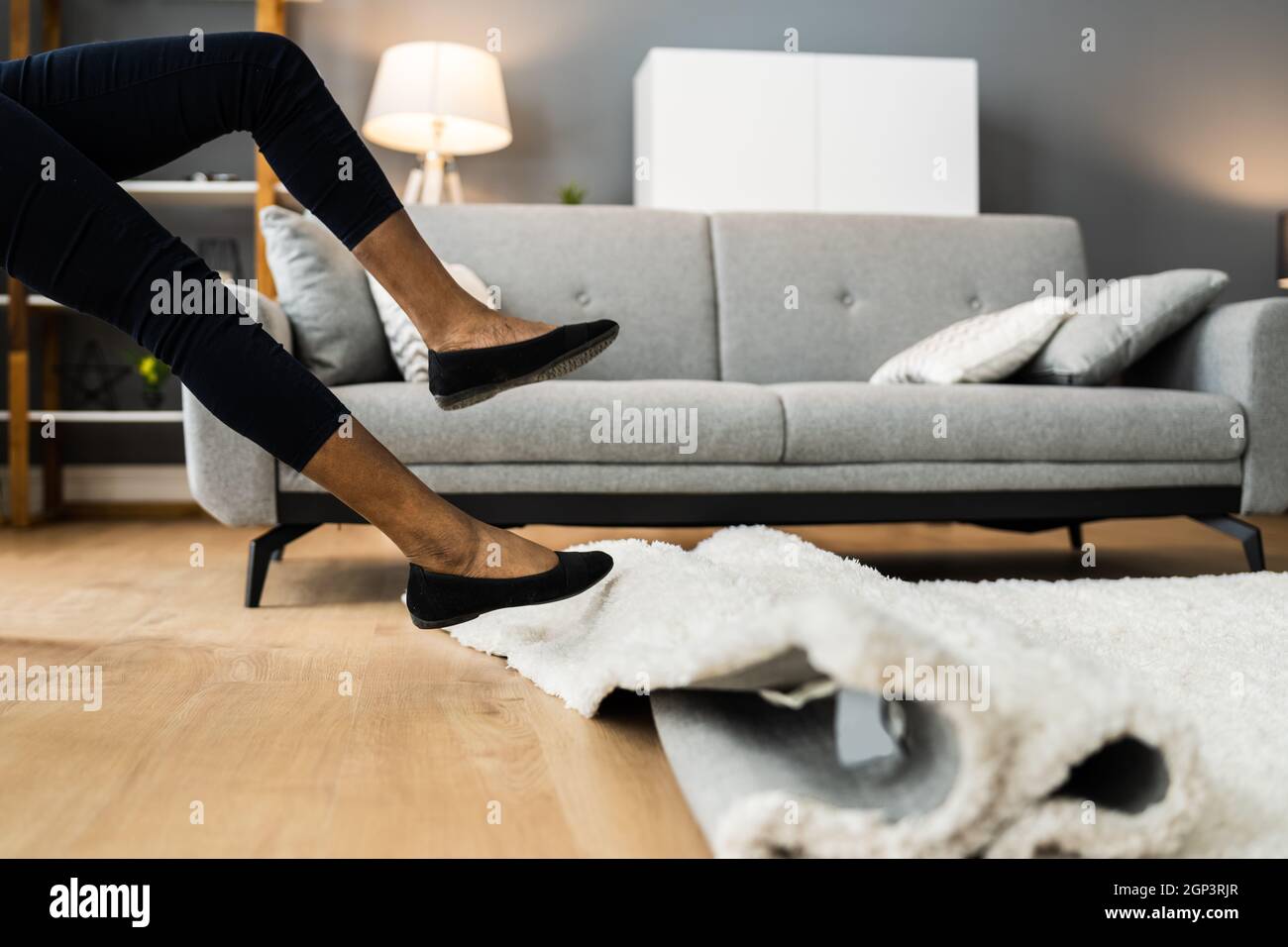 Falldown Hazard. Clumsy Woman Stumbled On Rug Stock Photo - Alamy