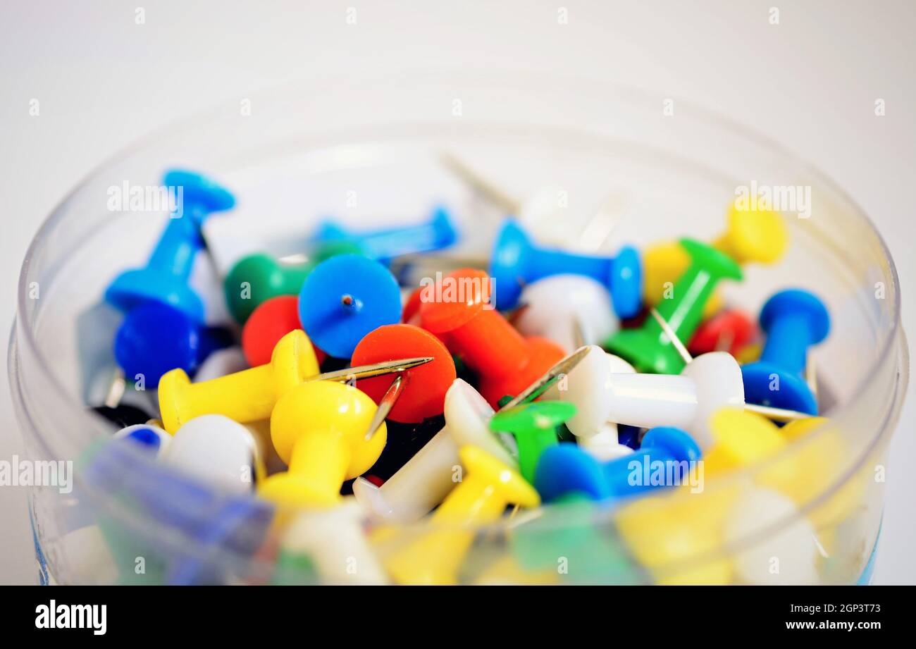 Heap of colorful office push pins on white background Stock Photo - Alamy