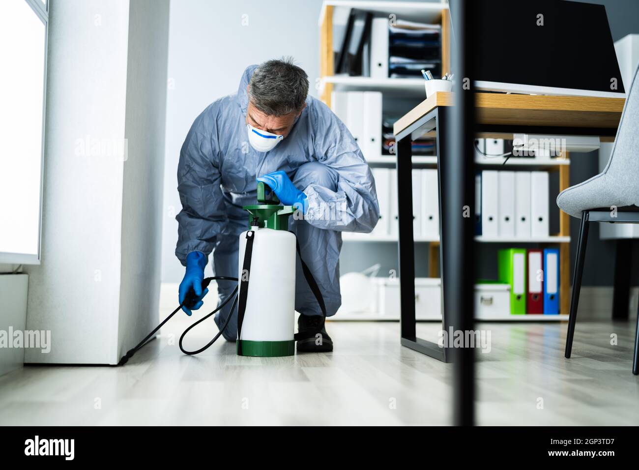 Pest Control Exterminator Man Spraying Termite Pesticide In Office ...