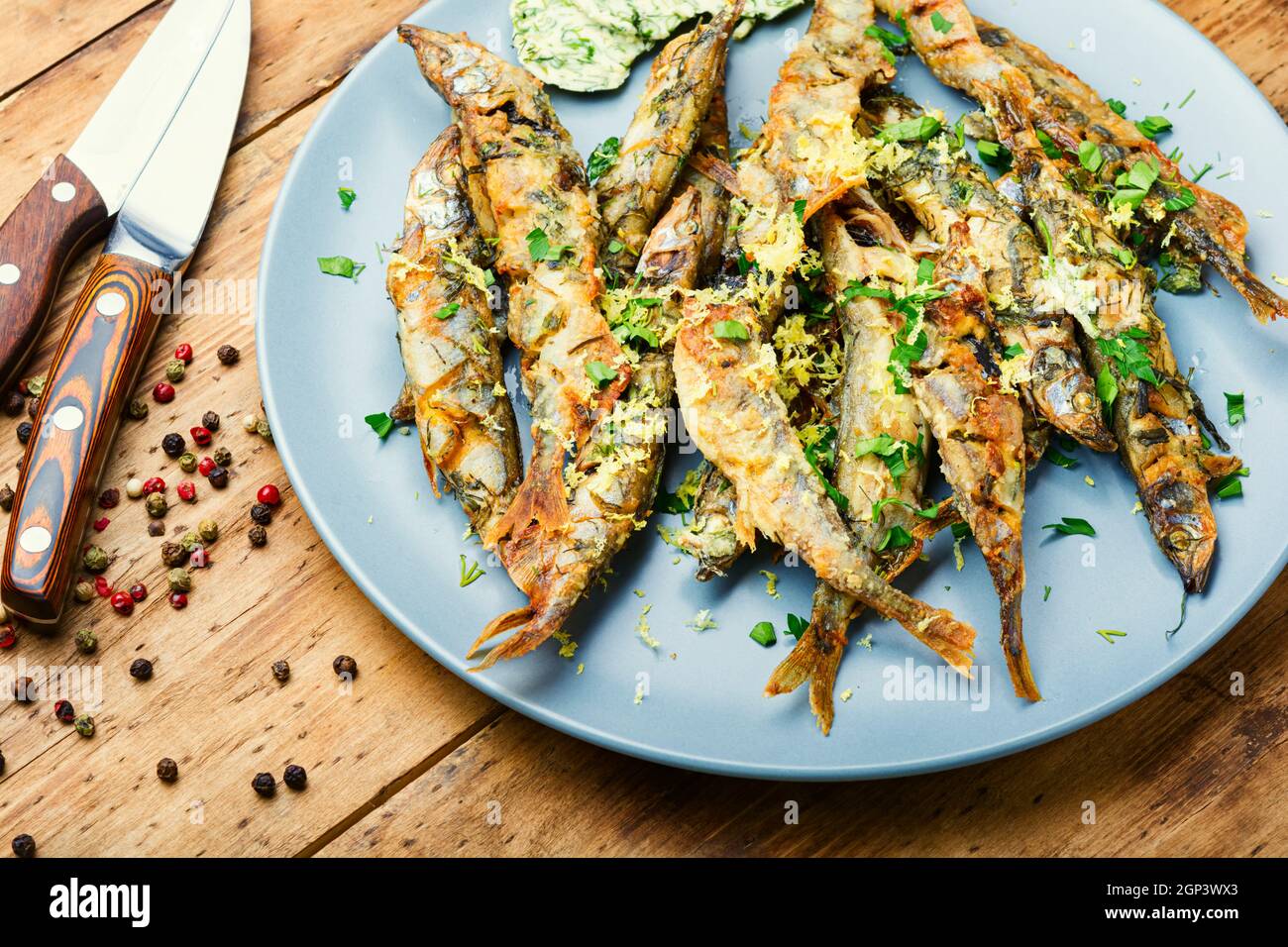 Fried capelin fish with herbs and lemon zest Stock Photo - Alamy
