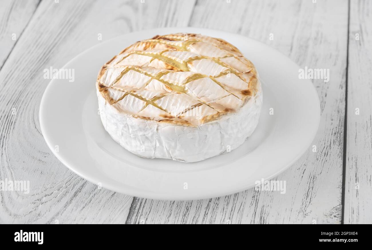 Grilled Camembert cheese on the serving plate Stock Photo - Alamy
