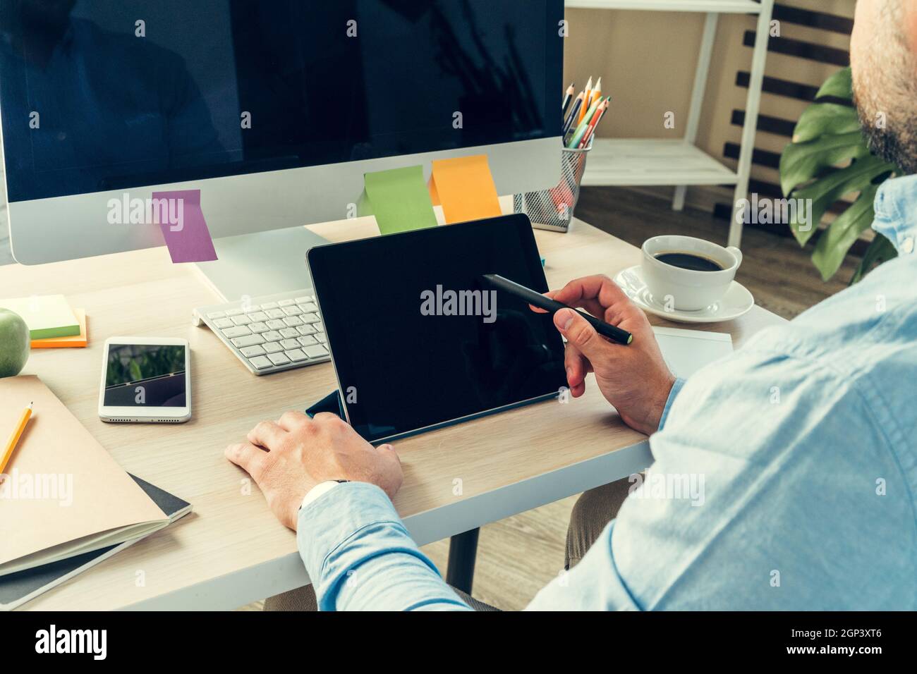 Office worker doing his job sitting at his working table with a ...