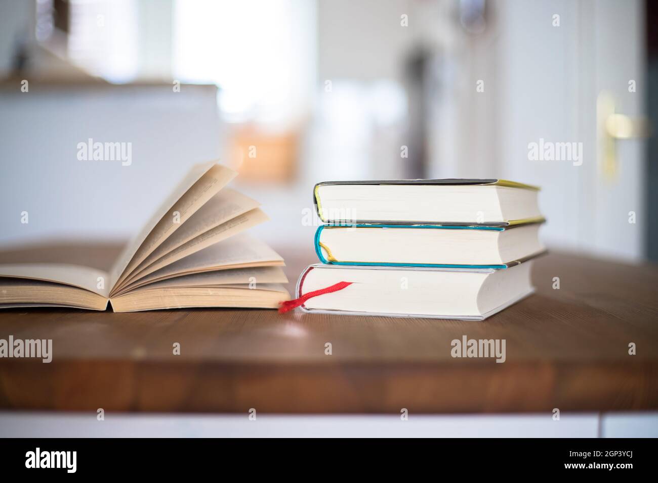 Stack of books lying on wooden desk at home. Knowledge and science ...