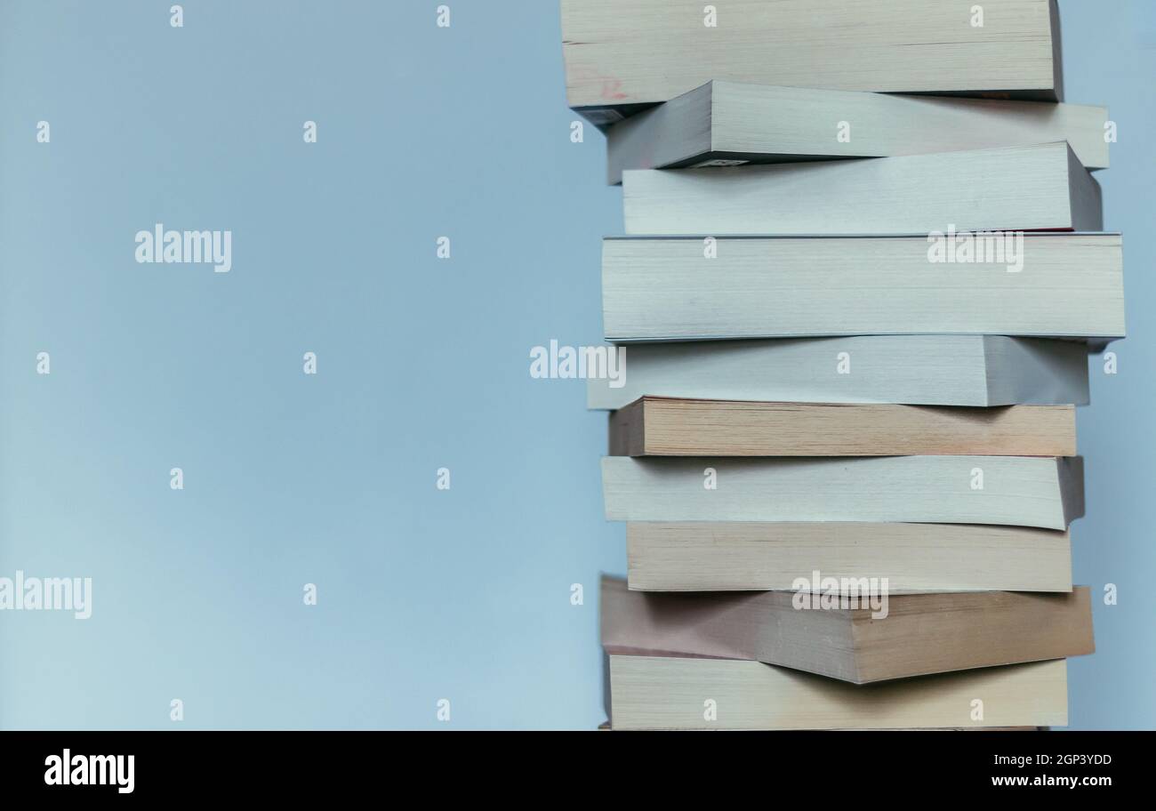 Stack of books before blue background, science concept Stock Photo - Alamy
