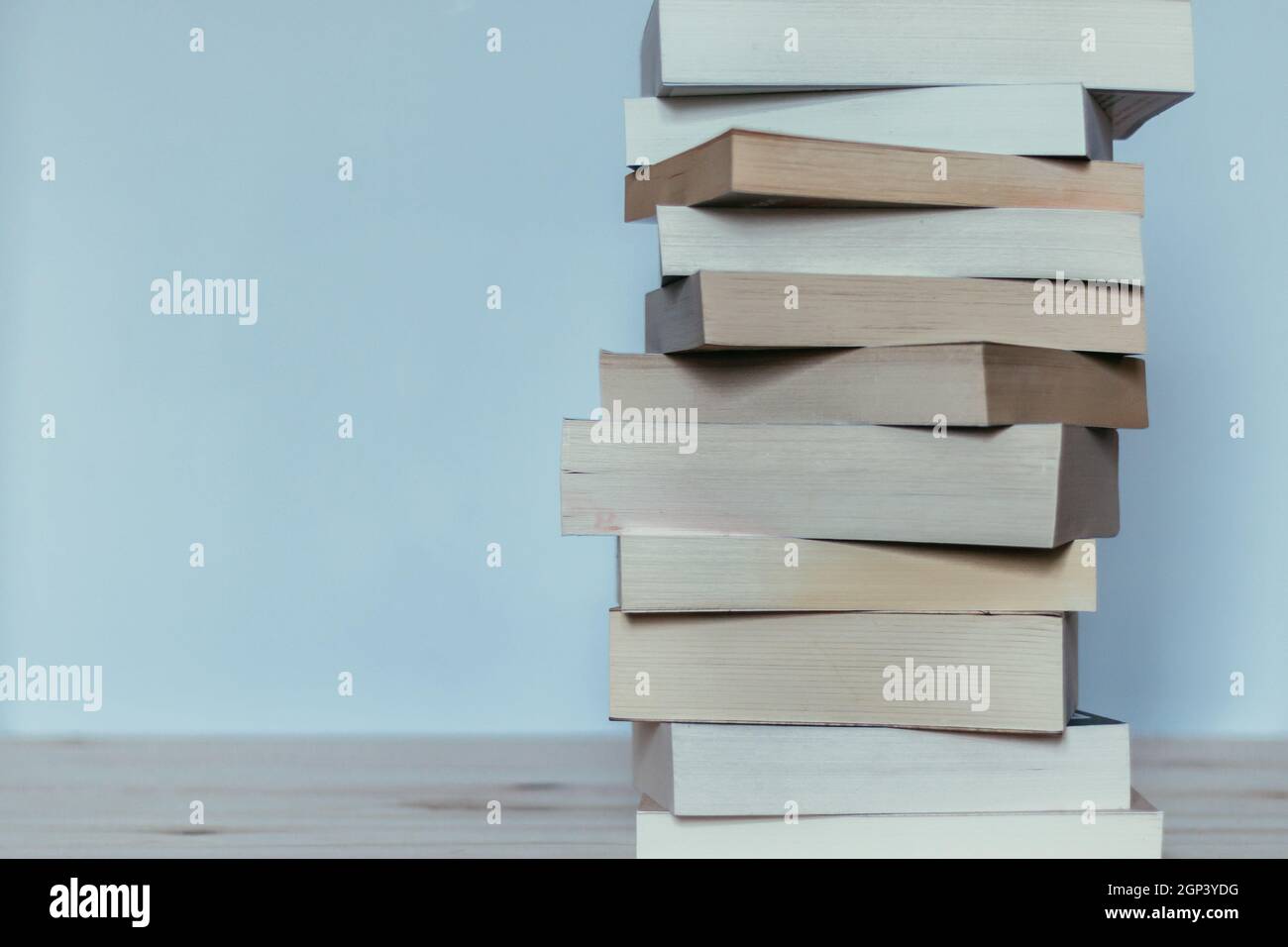 Stack of books before blue background, science concept Stock Photo - Alamy