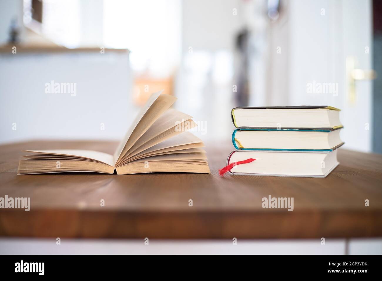 Stack of books lying on wooden desk at home. Knowledge and science ...