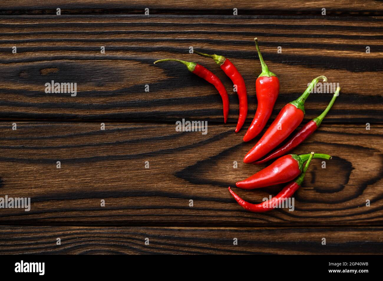 Fragrant red pepper isolated on wooden background, top view. Organic ...