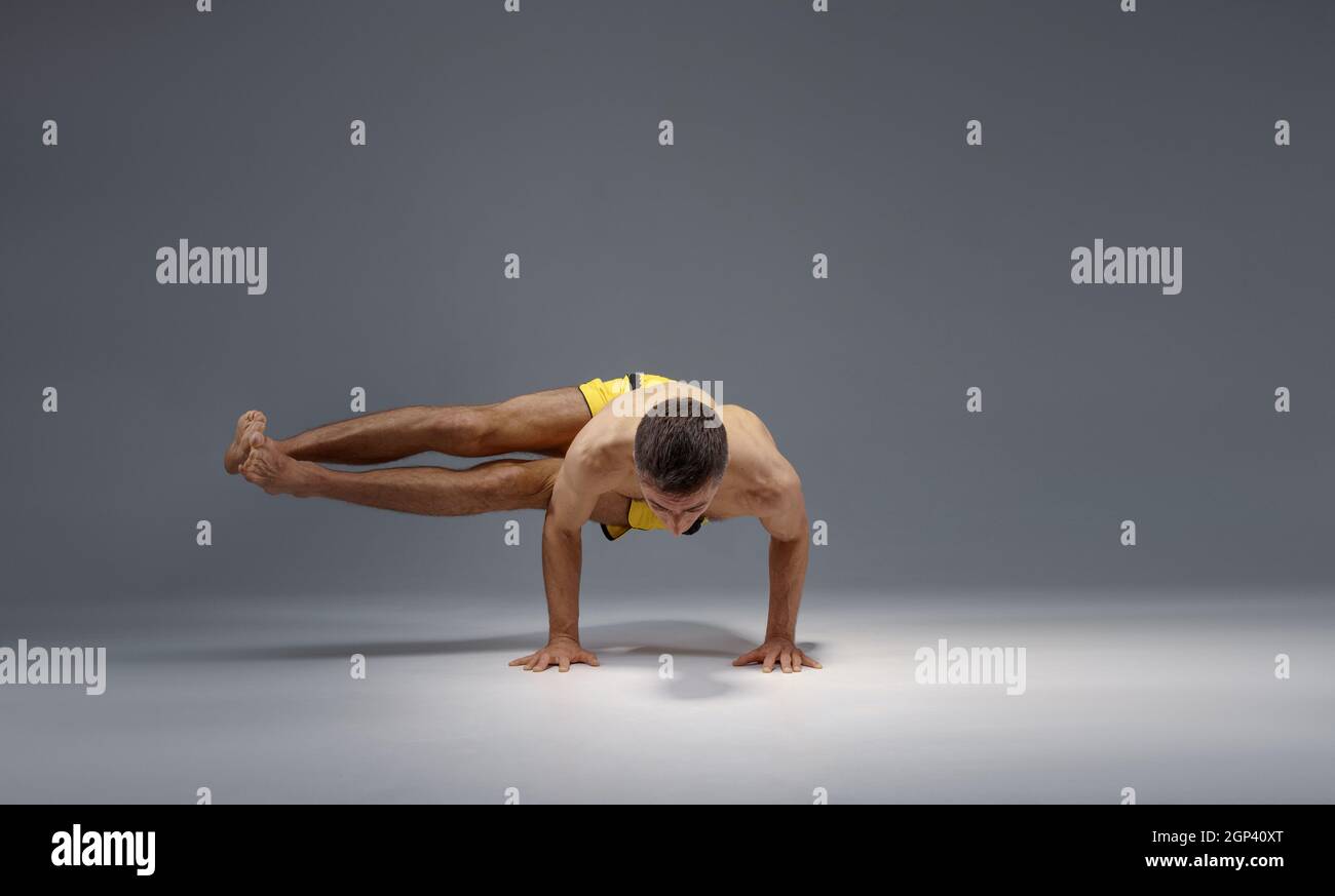 Muscular yoga stands on hands in difficult pose, meditation position ...
