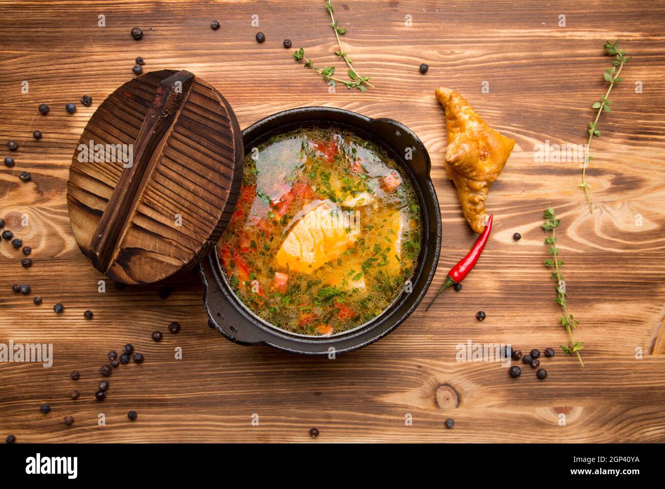 Hot fish broth, fish soup. Soup with vegetables and salmon, fish ...