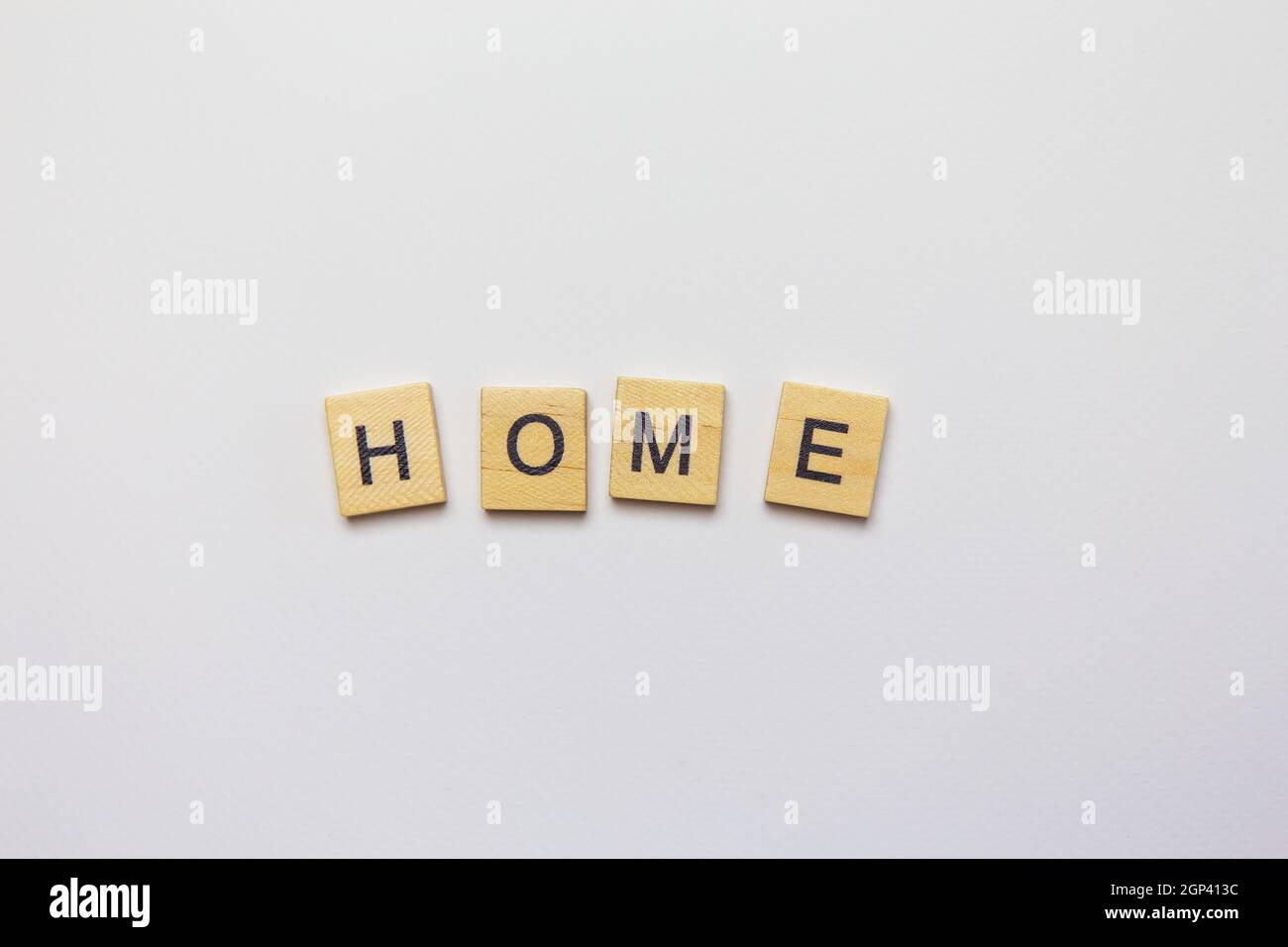 Decorative wooden letters forming the word home on a white background ...