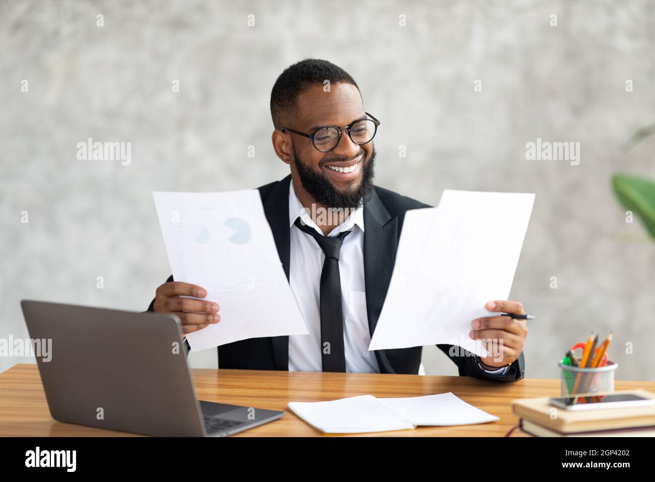 Paperwork Concept. Portrait of smiling African American man in suit and ...