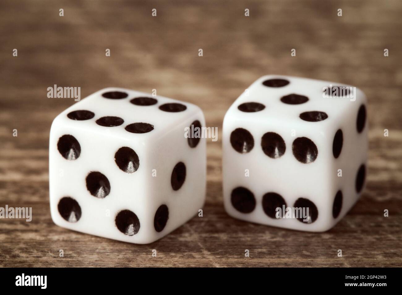 Two dice on dark wooden table background. Gambling concept Stock Photo ...