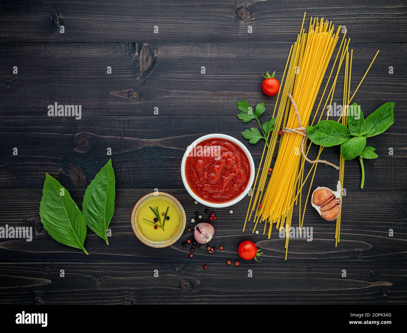The thin spaghetti on black wooden background. Yellow italian pasta ...
