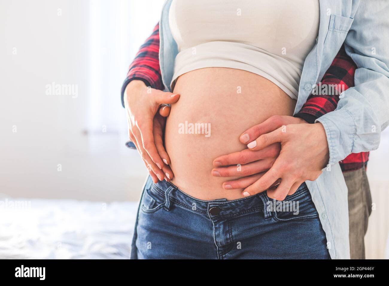 Close up of pregnant mother and father, hugging the tummy, Caucasian ...