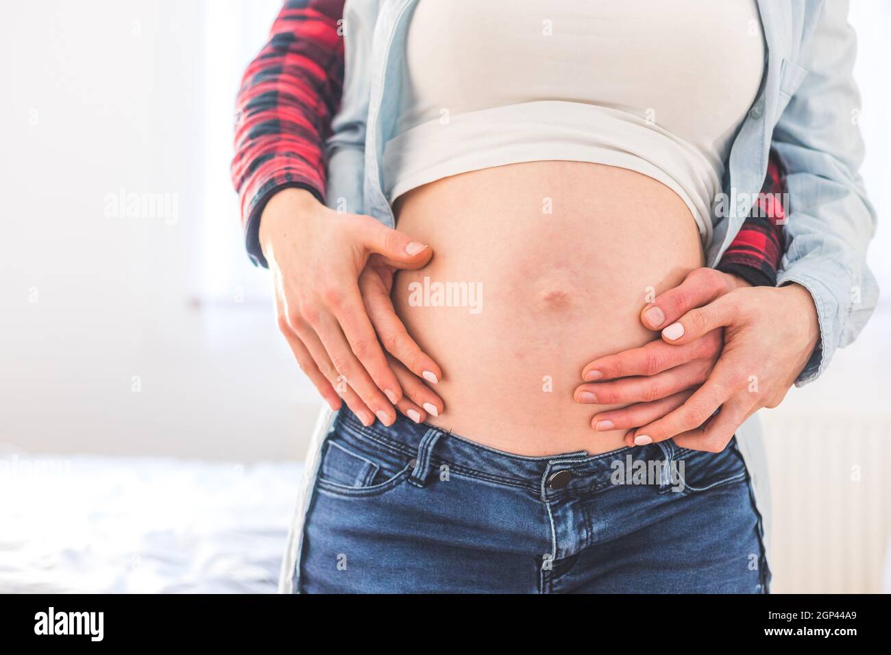 Close up of pregnant mother and father, hugging the tummy, Caucasian ...