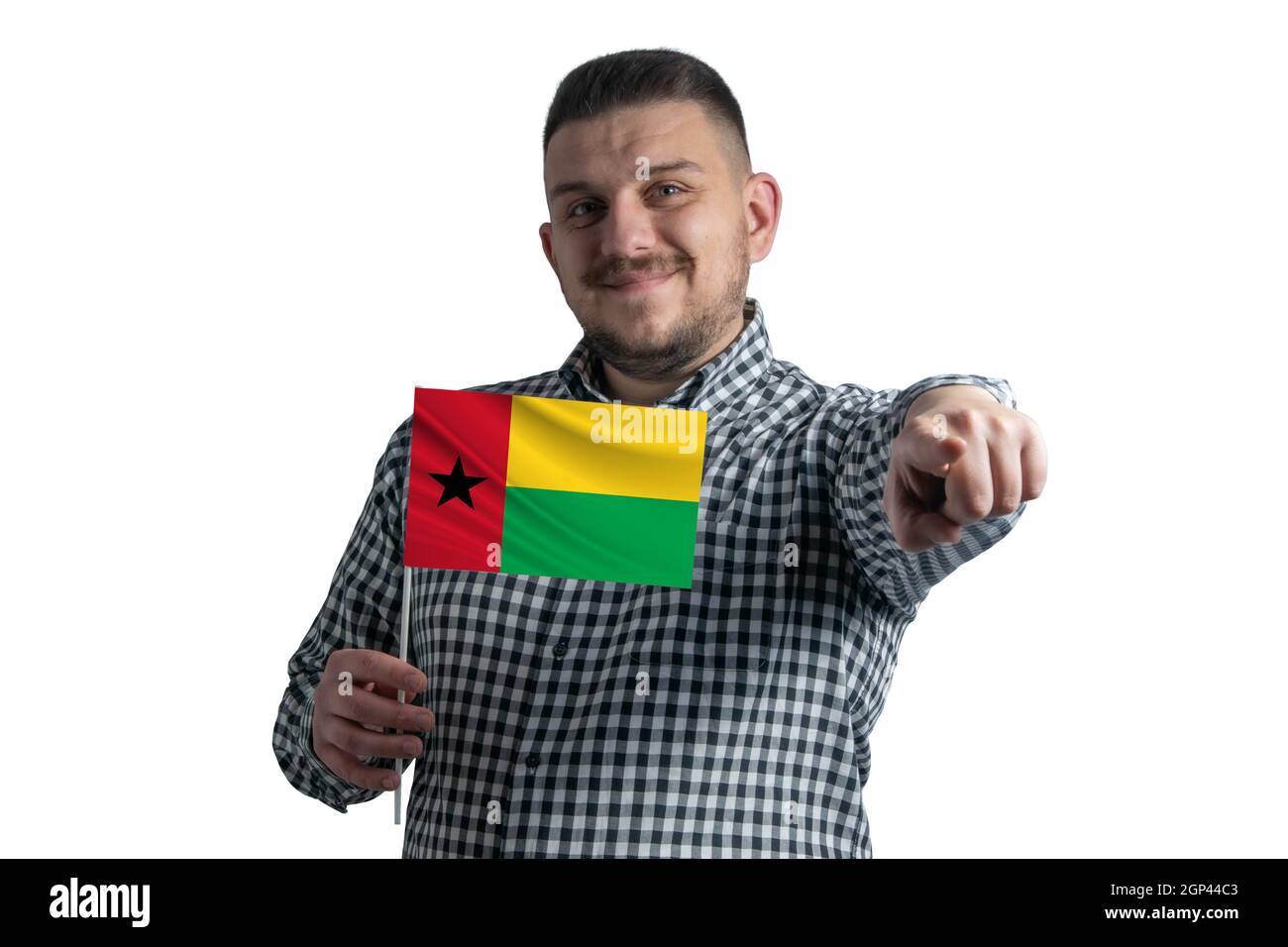 White guy holding a flag of Guinea-Bissau and points forward in front ...