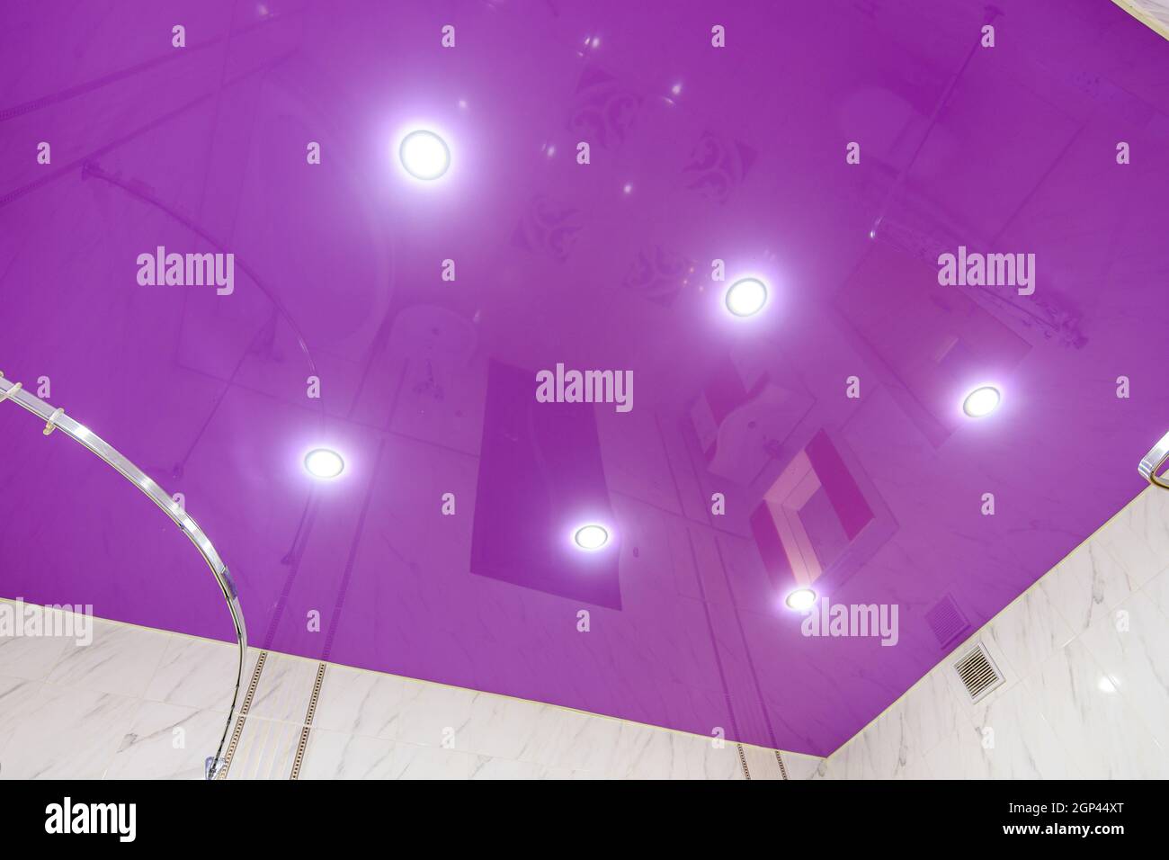 Stretch glossy ceiling of bright purple color in the bathroom Stock ...