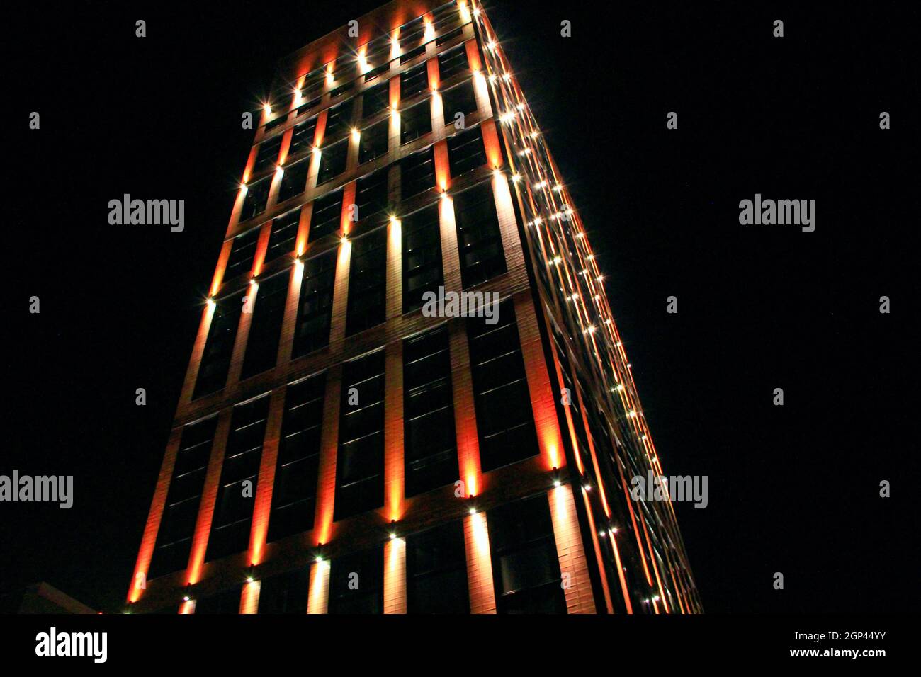 Beautiful illumination on modern skyscraper in night city. illuminated ...