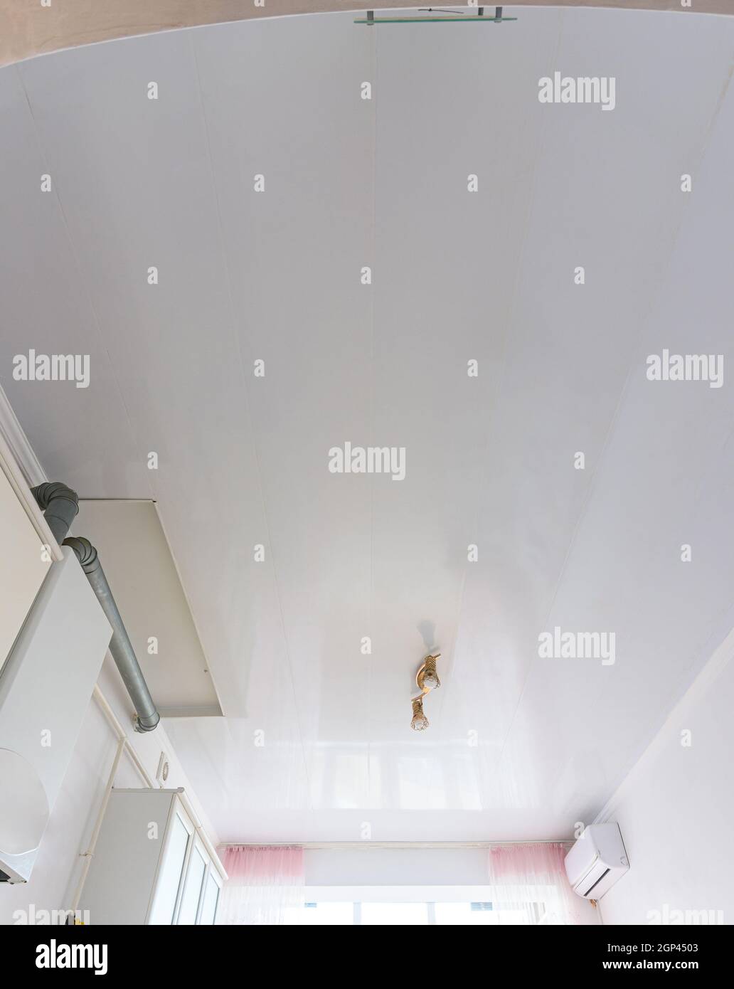 Ceiling made of white plastic panels in the interior of the kitchen ...