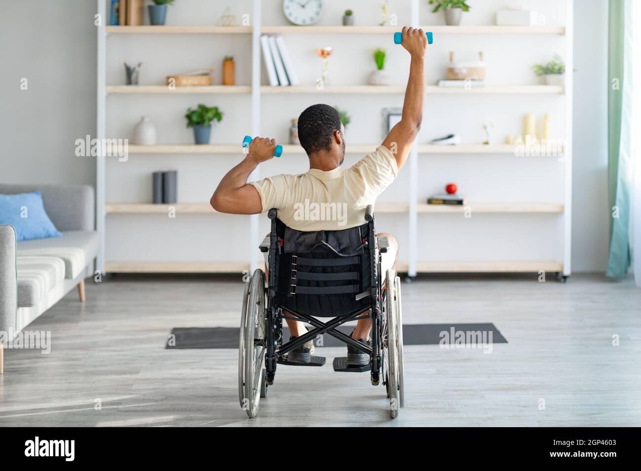Back view of praplegic black guy in wheelchair working out with ...