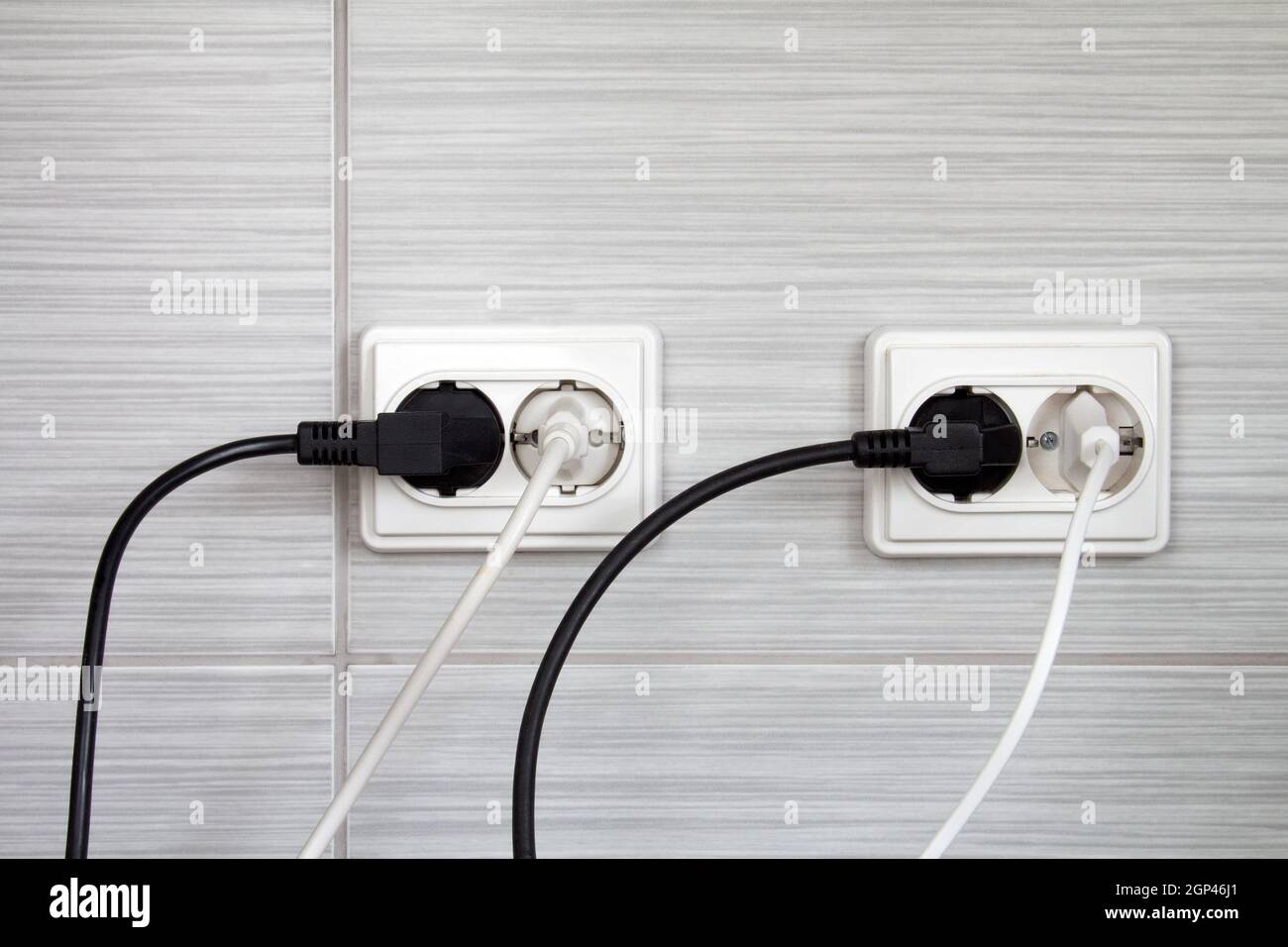 Electrical plugs connected into the wall sockets Stock Photo - Alamy