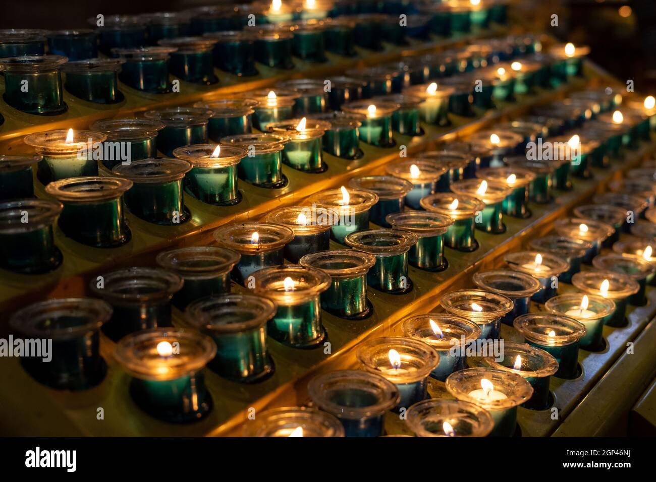 collection of lit candles on a catholic church Stock Photo - Alamy