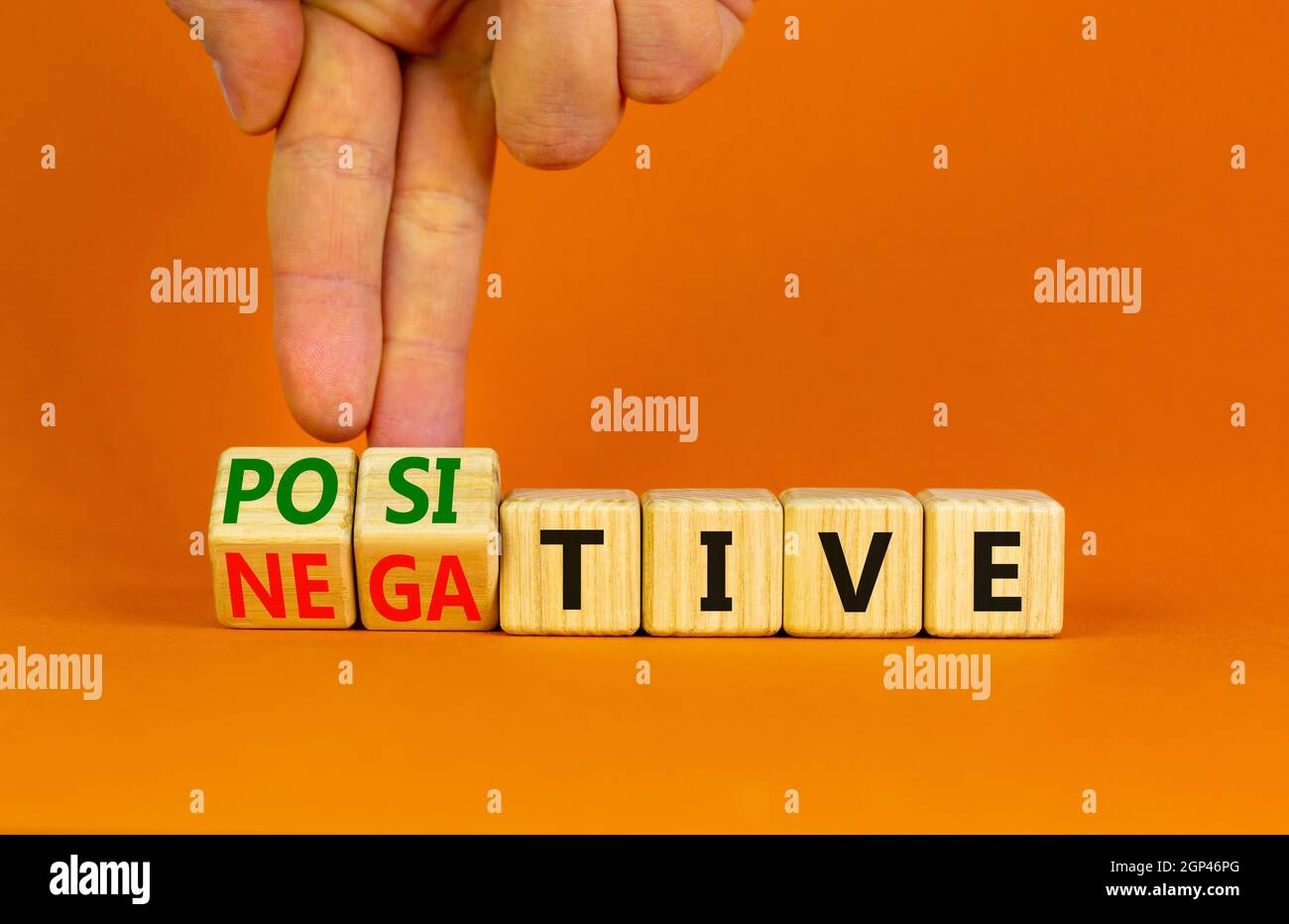 Positive or negative symbol. Businessman turns wooden cubes and changes ...
