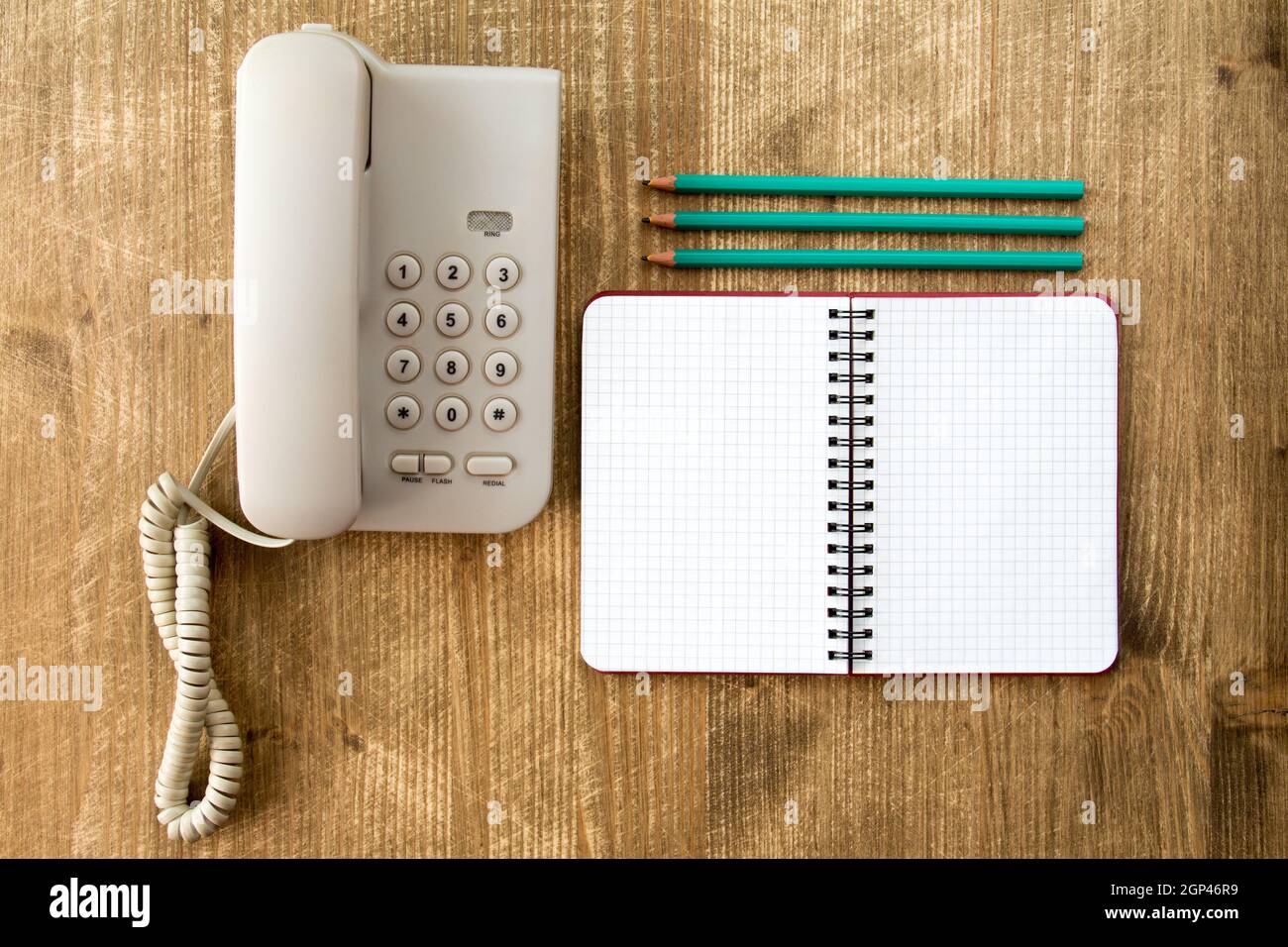 Touch tone telephone,blank notebook and three pencils Stock Photo - Alamy