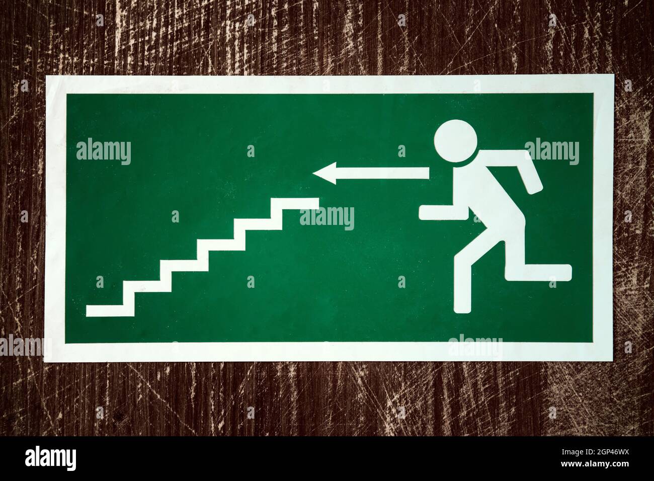 Green emergency fire exit with arrow direction to left side Stock Photo ...