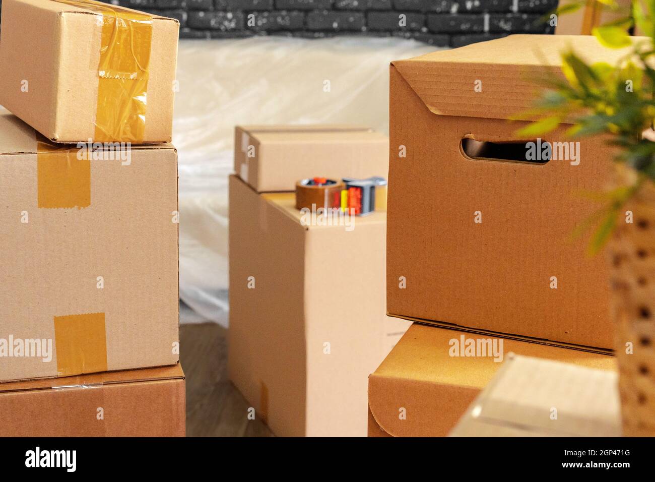 Moving in or moving out concept. Stack of boxes and packed furniture ...