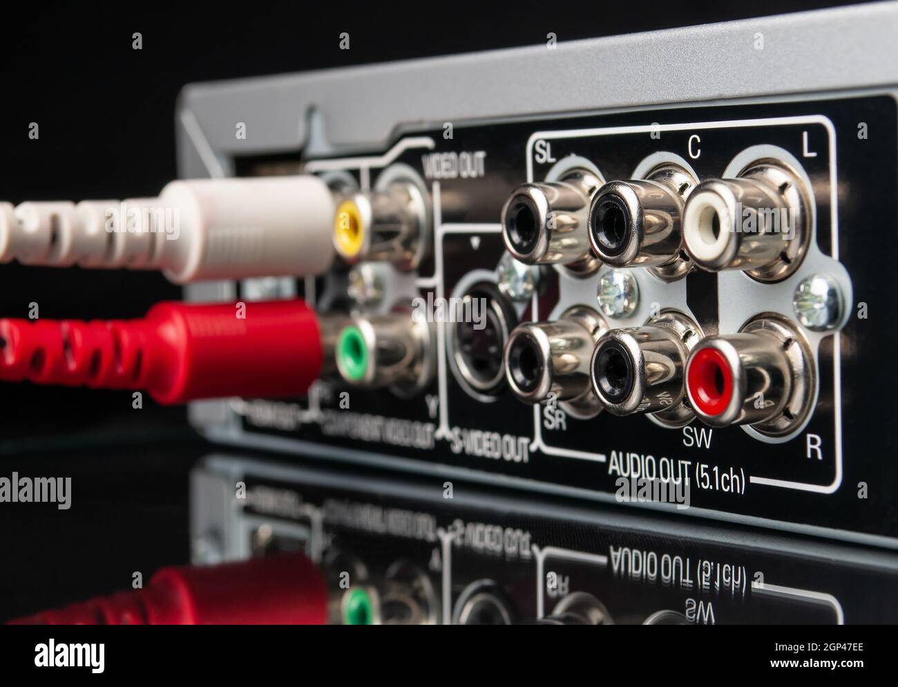 modern multimedia and audio equipment with attached cables on black ...