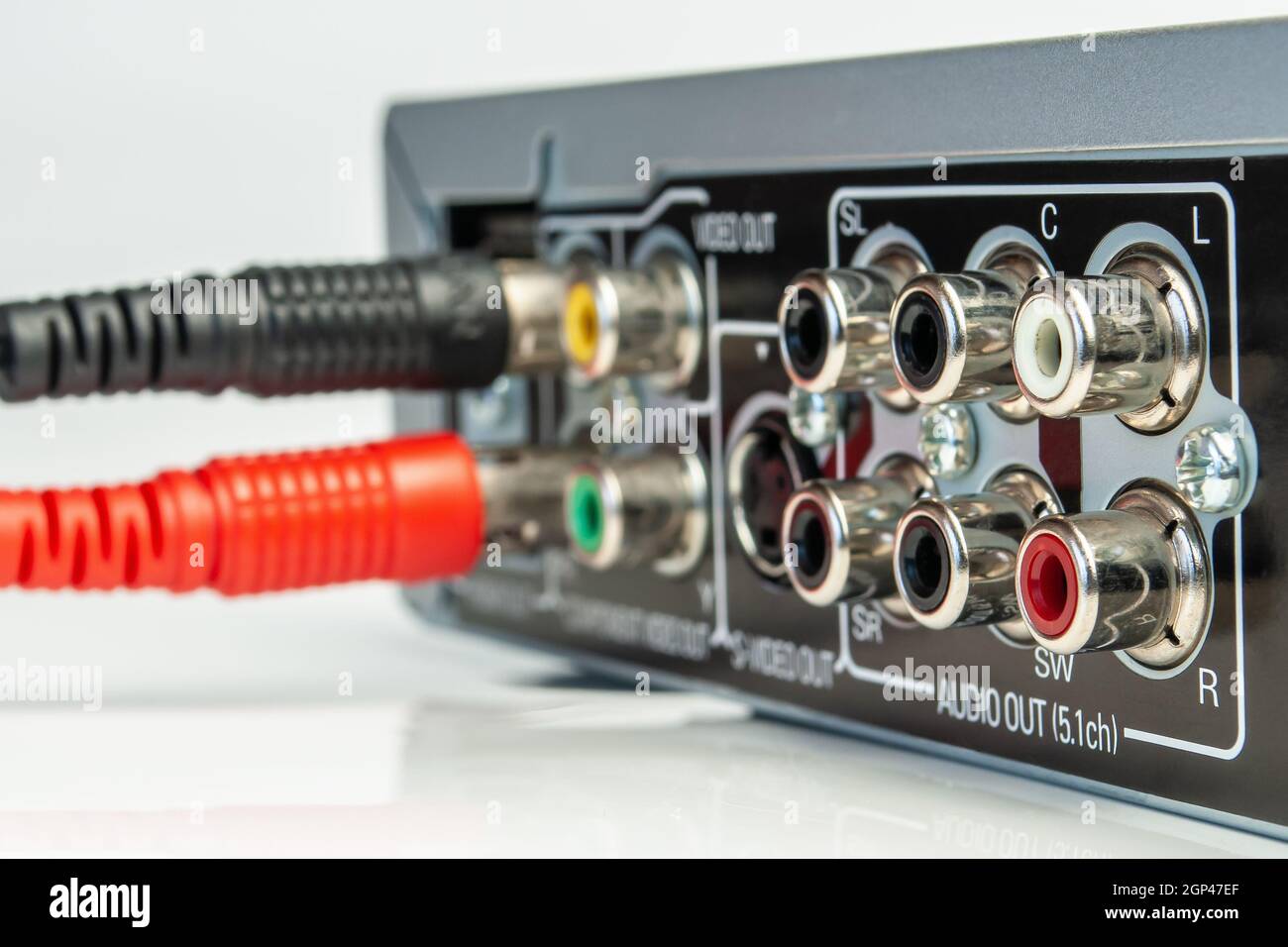 modern multimedia and audio equipment with attached cables on white ...