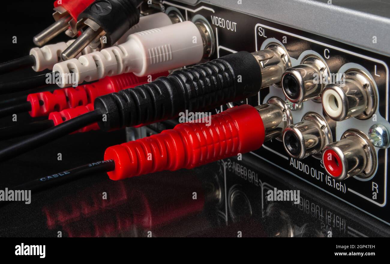 modern multimedia and audio equipment with attached cables on black ...