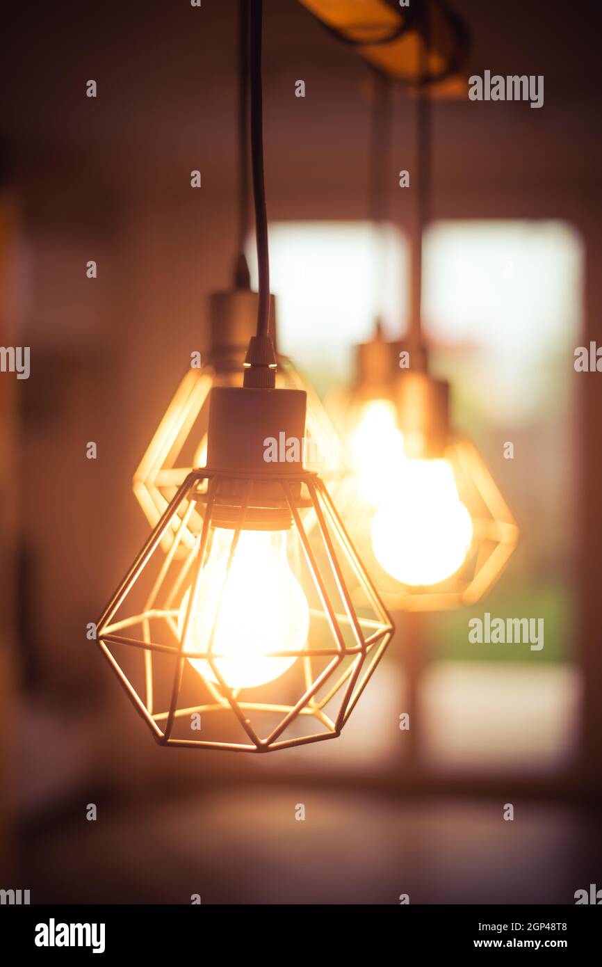 Close up picture of a hanging orange lightbulbs at home, in a ...
