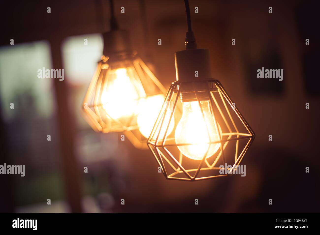 Close up picture of a hanging orange lightbulbs at home, in a ...