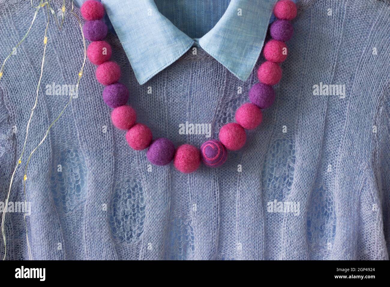 Handmade wool necklace on the background of clothes Stock Photo - Alamy