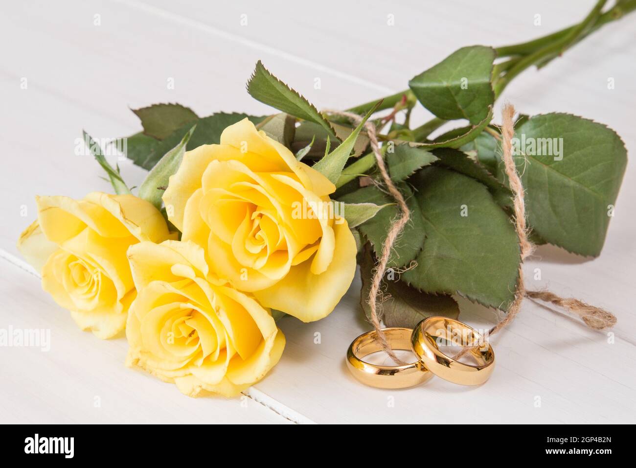 Two gold wedding rings tied hi-res stock photography and images - Alamy