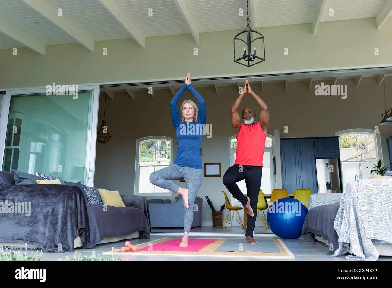 Happy diverse couple practicing yoga hi-res stock photography and ...