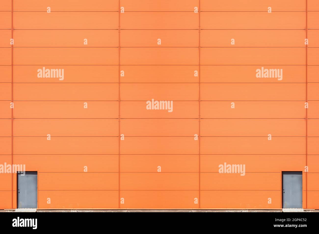 Modern industrial building wall with metal doors Stock Photo - Alamy