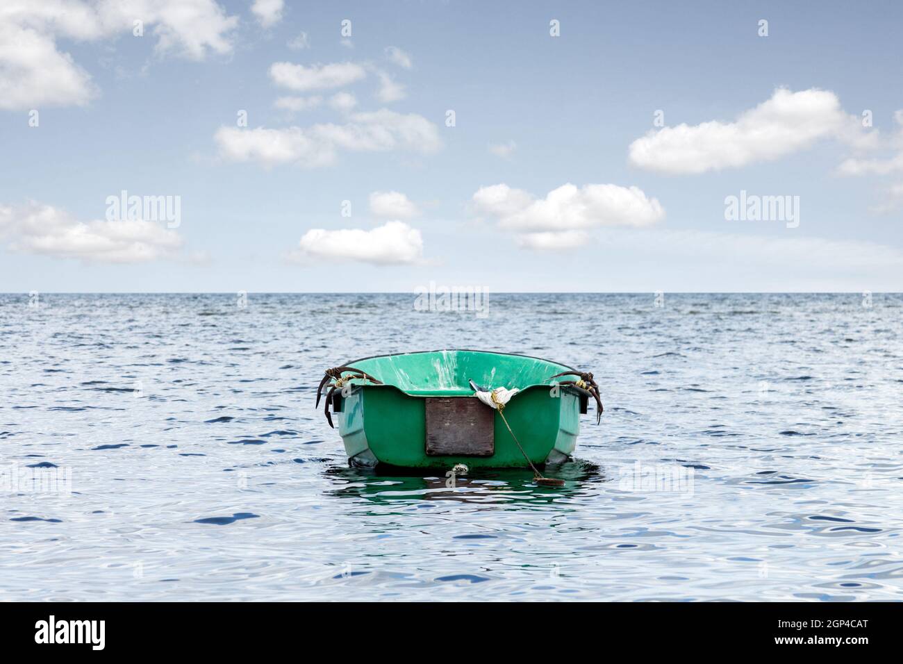 Empty wooden boat floating out to sea Stock Photo - Alamy