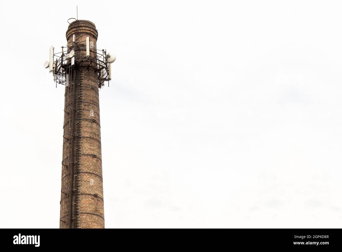 Old brick chimney with antennas on cloudy sky background Stock Photo ...