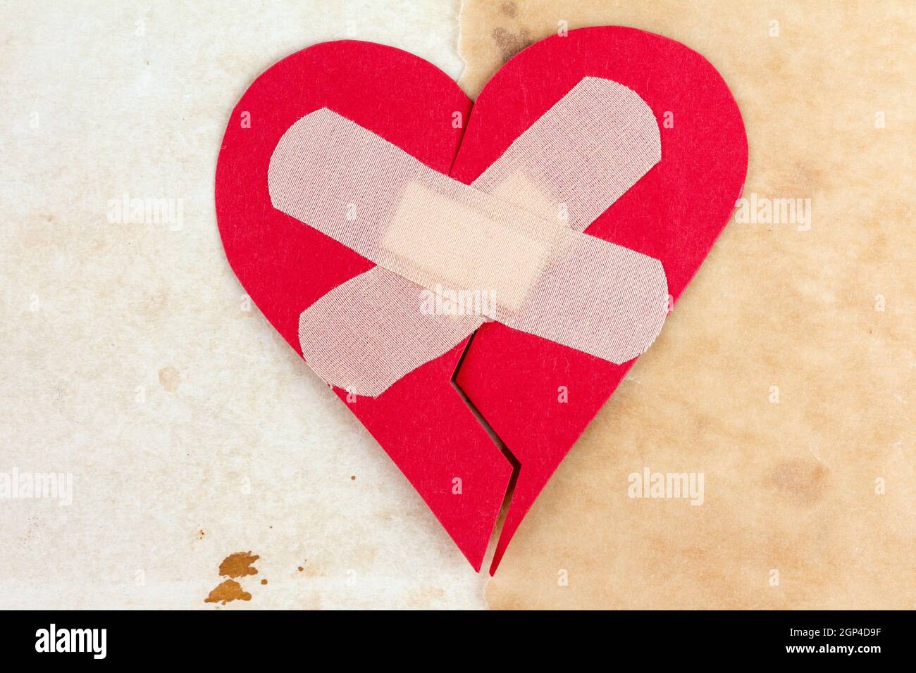 Concept image: A broken heart with bandage Stock Photo - Alamy