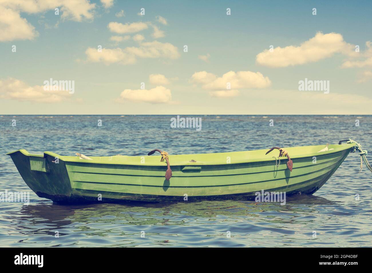 A single wooden boat floating out to sea Stock Photo - Alamy