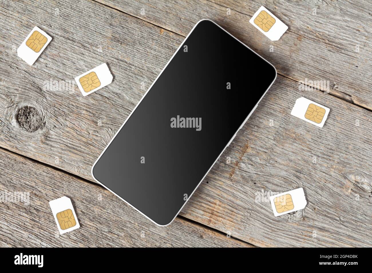 Smartphone with blank screen and SIM cards on the table, top view Stock ...
