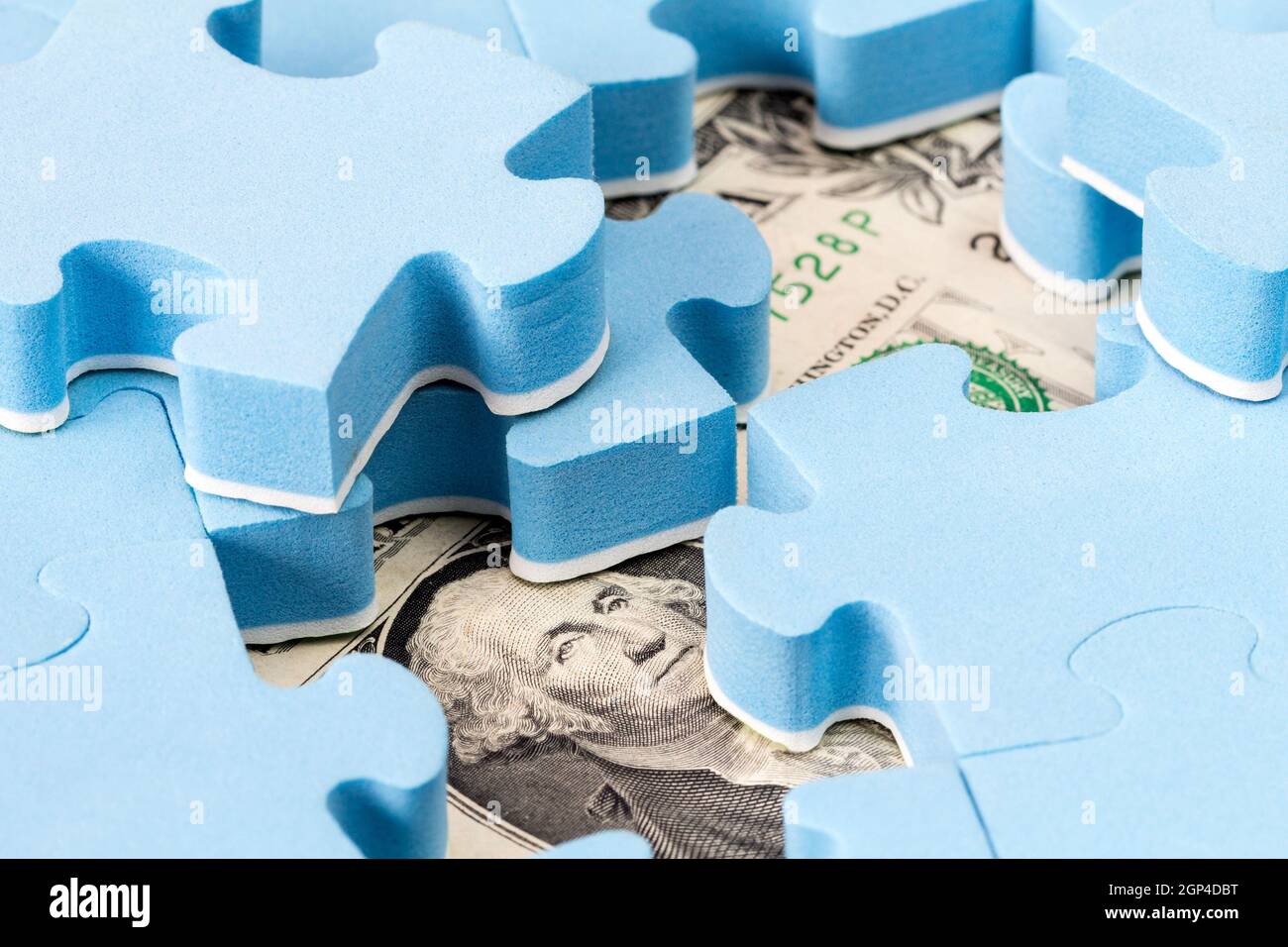 US dollar banknote hidden under puzzle, financial concept Stock Photo ...