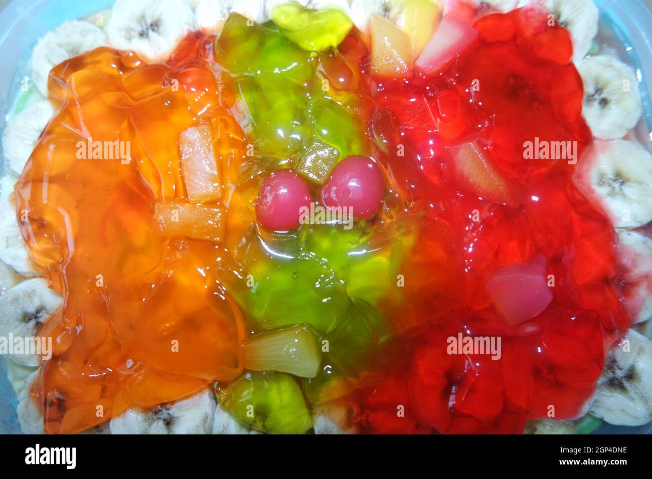 Creamy custard sweet dish with with different slices layered on surface ...